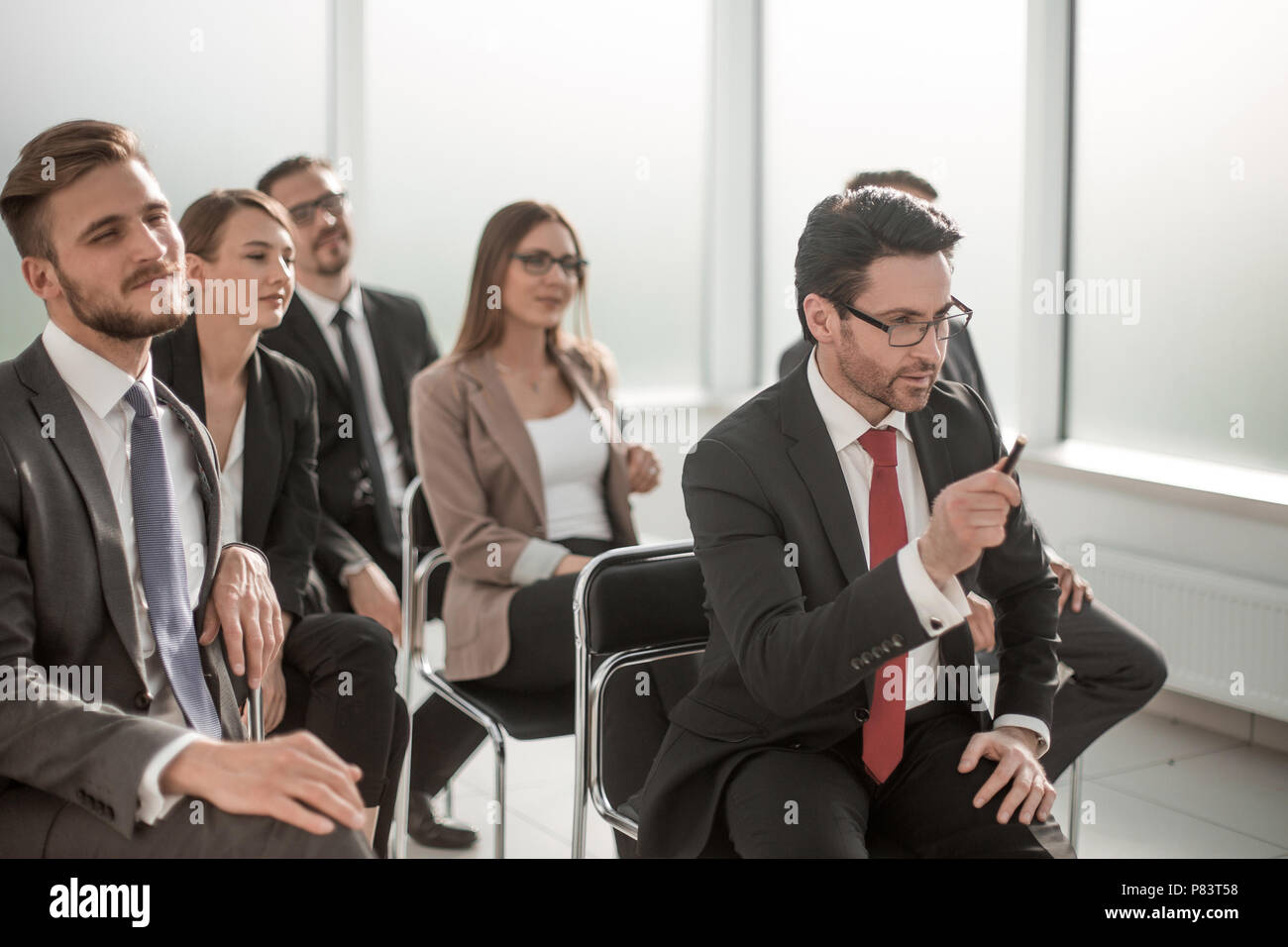 Manager asks a question at a business meeting Stock Photo - Alamy