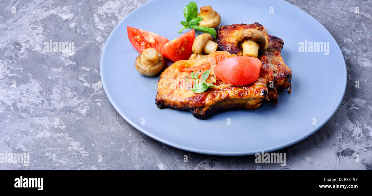 Grilled meat steak,tomato, herbs and spices on the plate.Bbq meat Stock ...