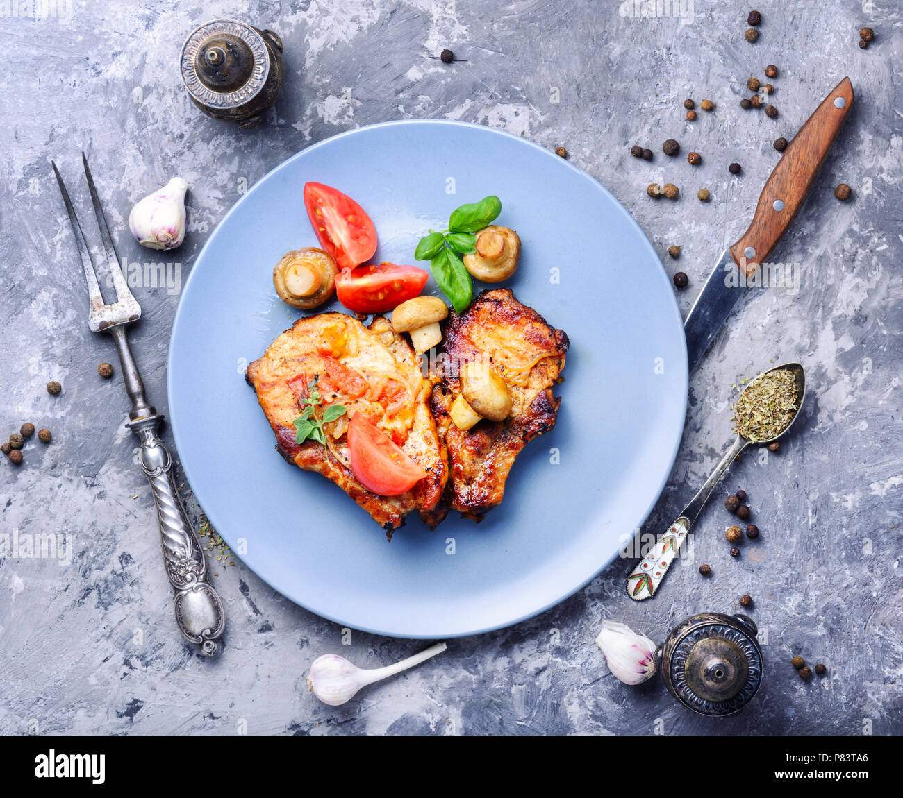 Grilled meat steak,tomato, herbs and spices on the plate.Bbq meat Stock ...