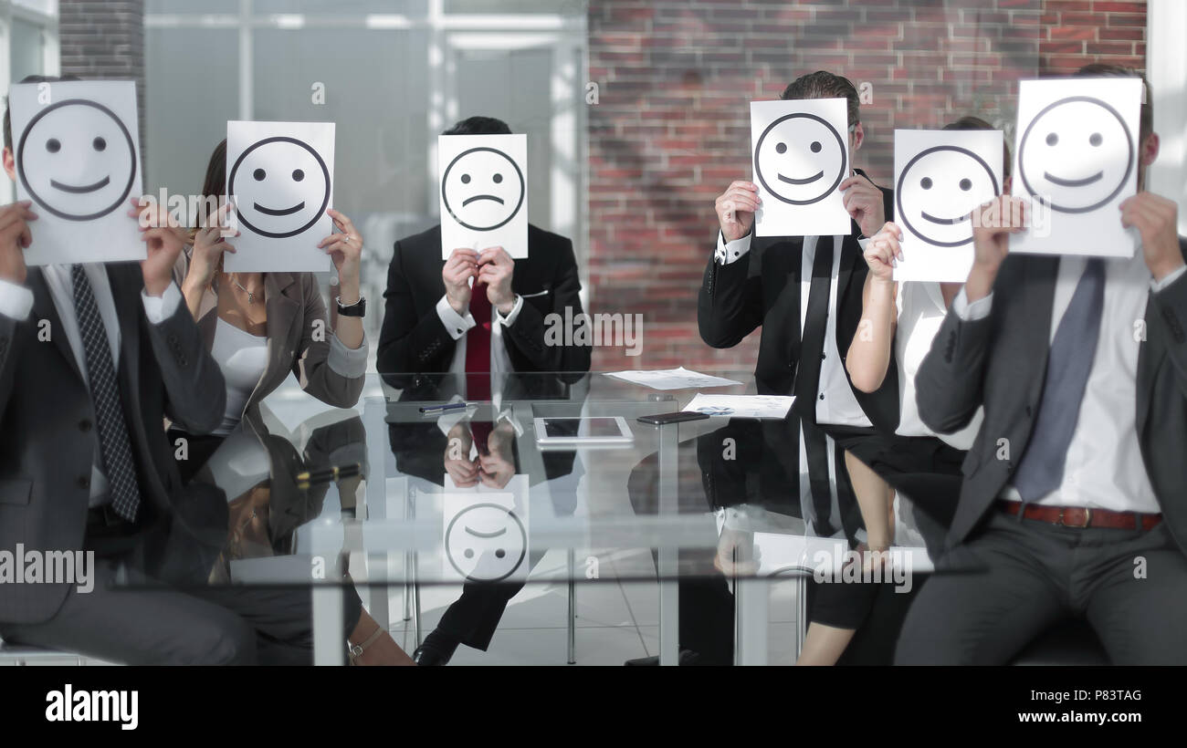 business team with smiley icons sitting at the Desk Stock Photo - Alamy