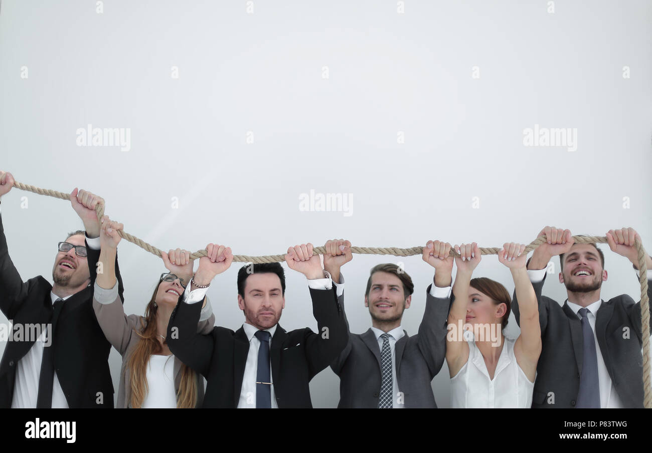 smiling business team is holding on to a strong rope Stock Photo - Alamy