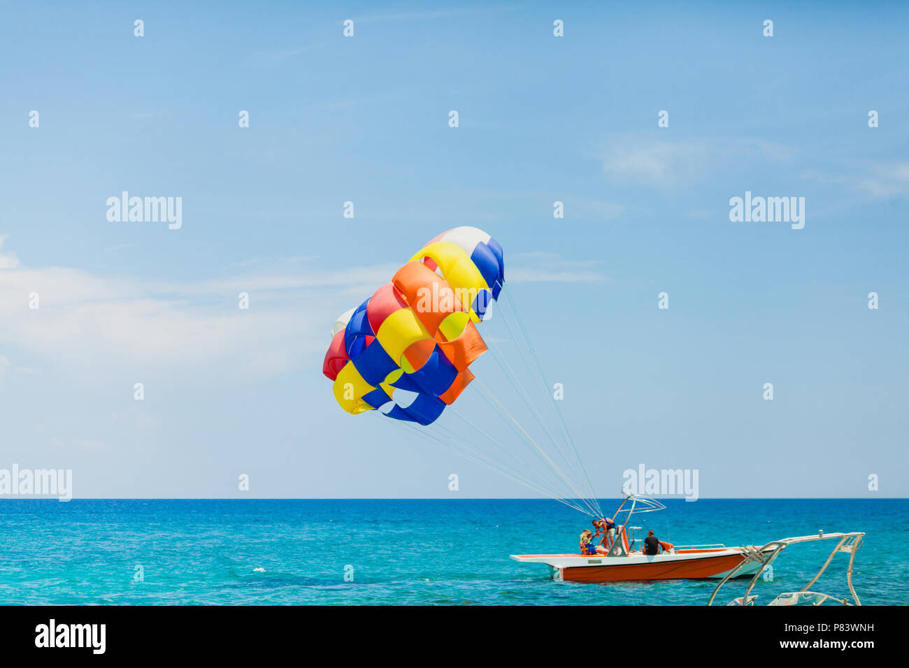 Parasailing water amusement - flying on a parachute behind a boat on a ...