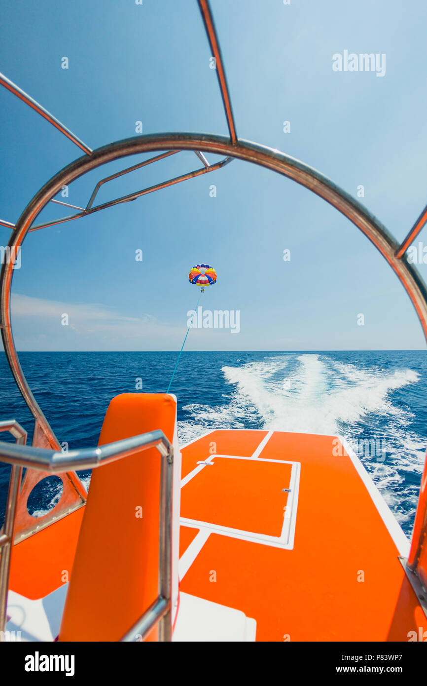 Parasailing water amusement - flying on a parachute behind a boat on a ...