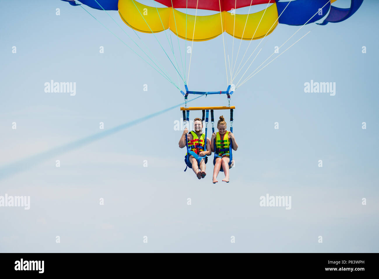 Parasailing water amusement - flying on a parachute behind a boat on a ...