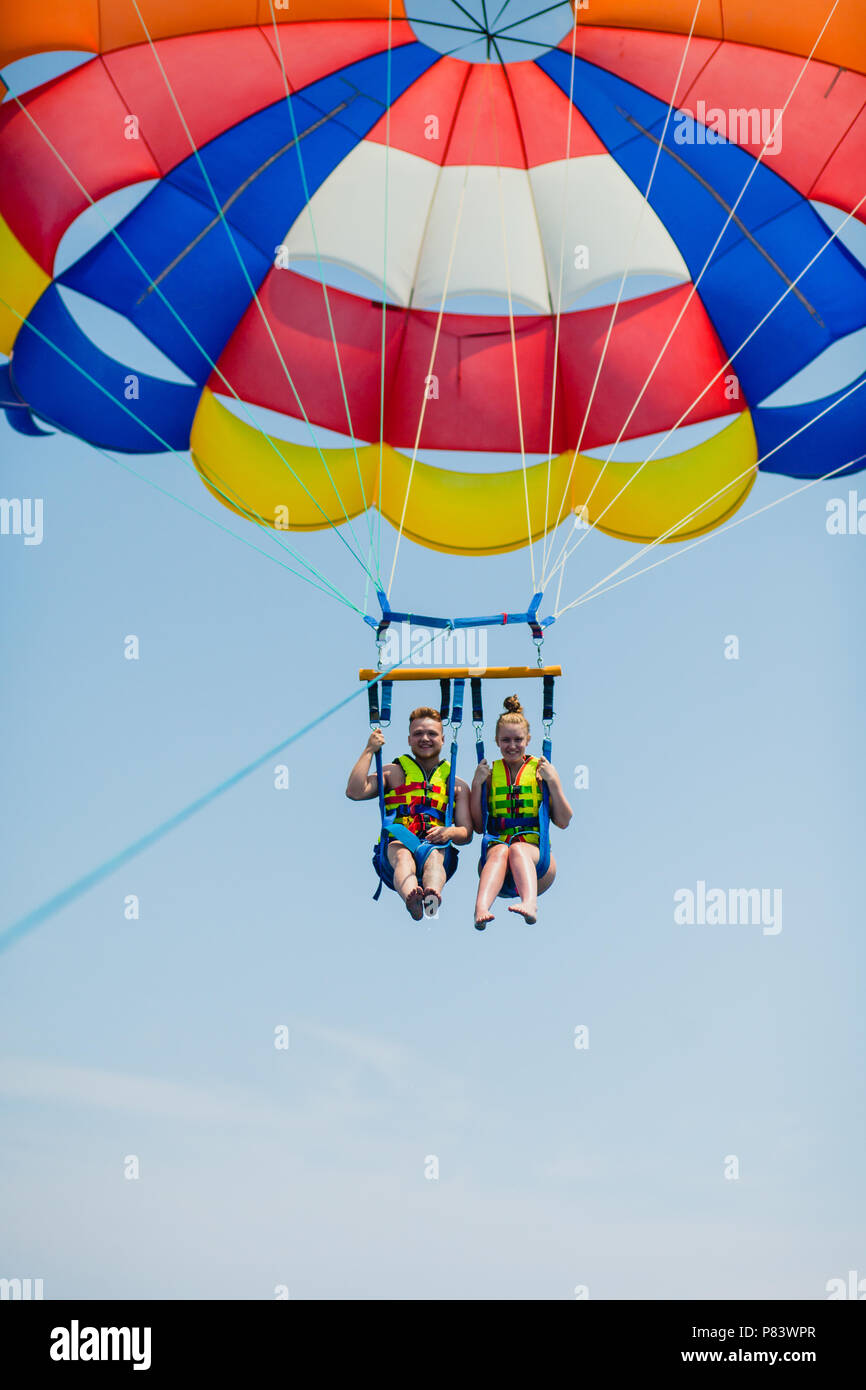 Parasailing water amusement - flying on a parachute behind a boat on a ...