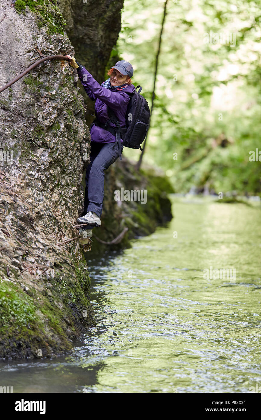 Woman climbing over wall hi-res stock photography and images - Alamy