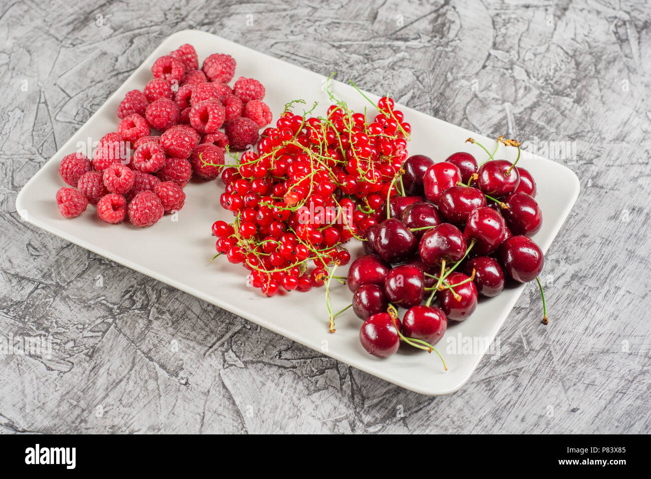 mixed many different colorful seasonal fruits, raspberries, cherries ...