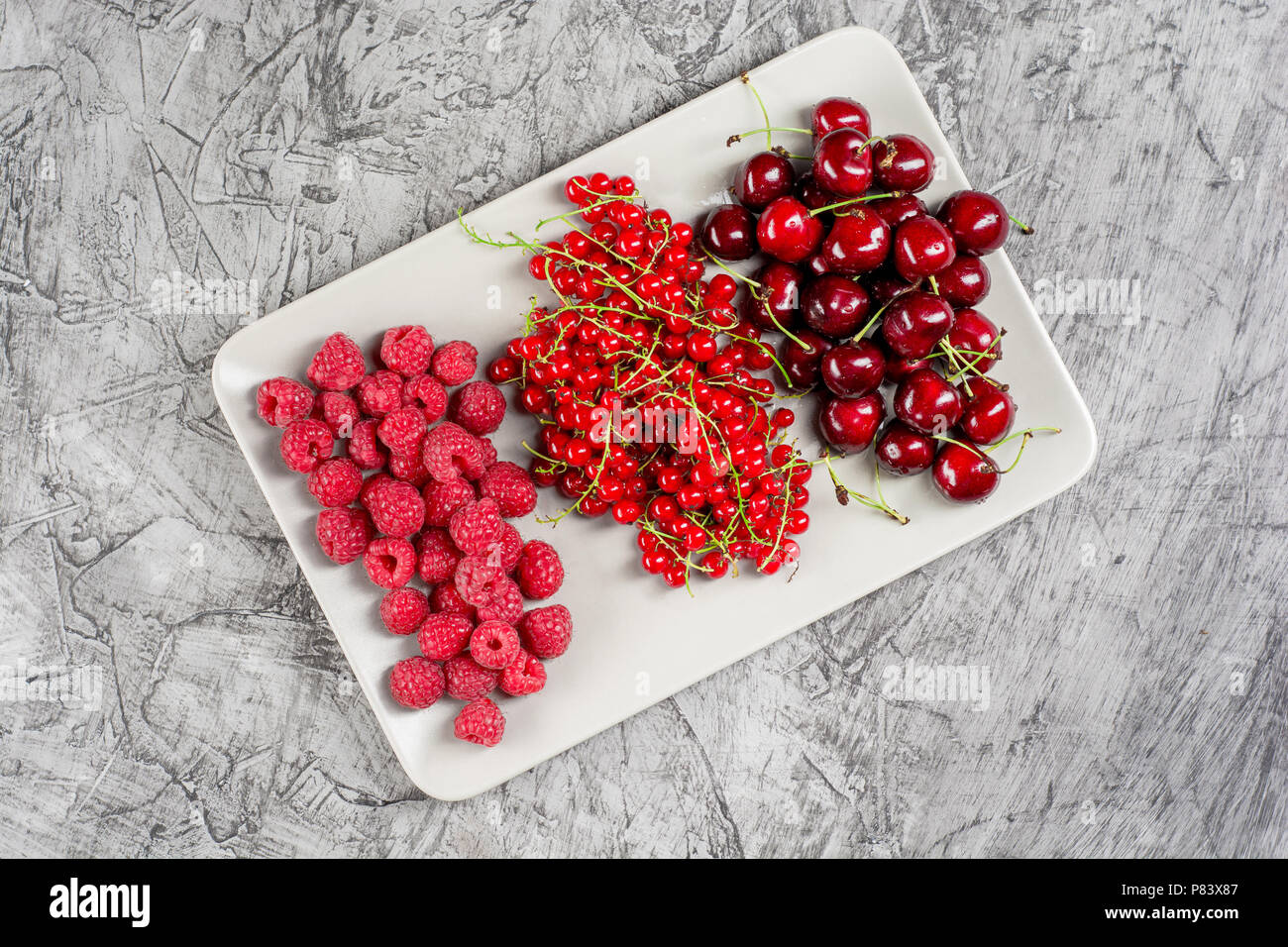 mixed many different colorful seasonal fruits, raspberries, cherries ...