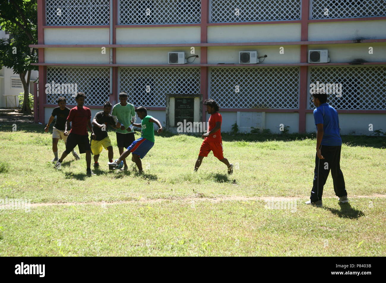 College students play football in the practice Stock Photo - Alamy