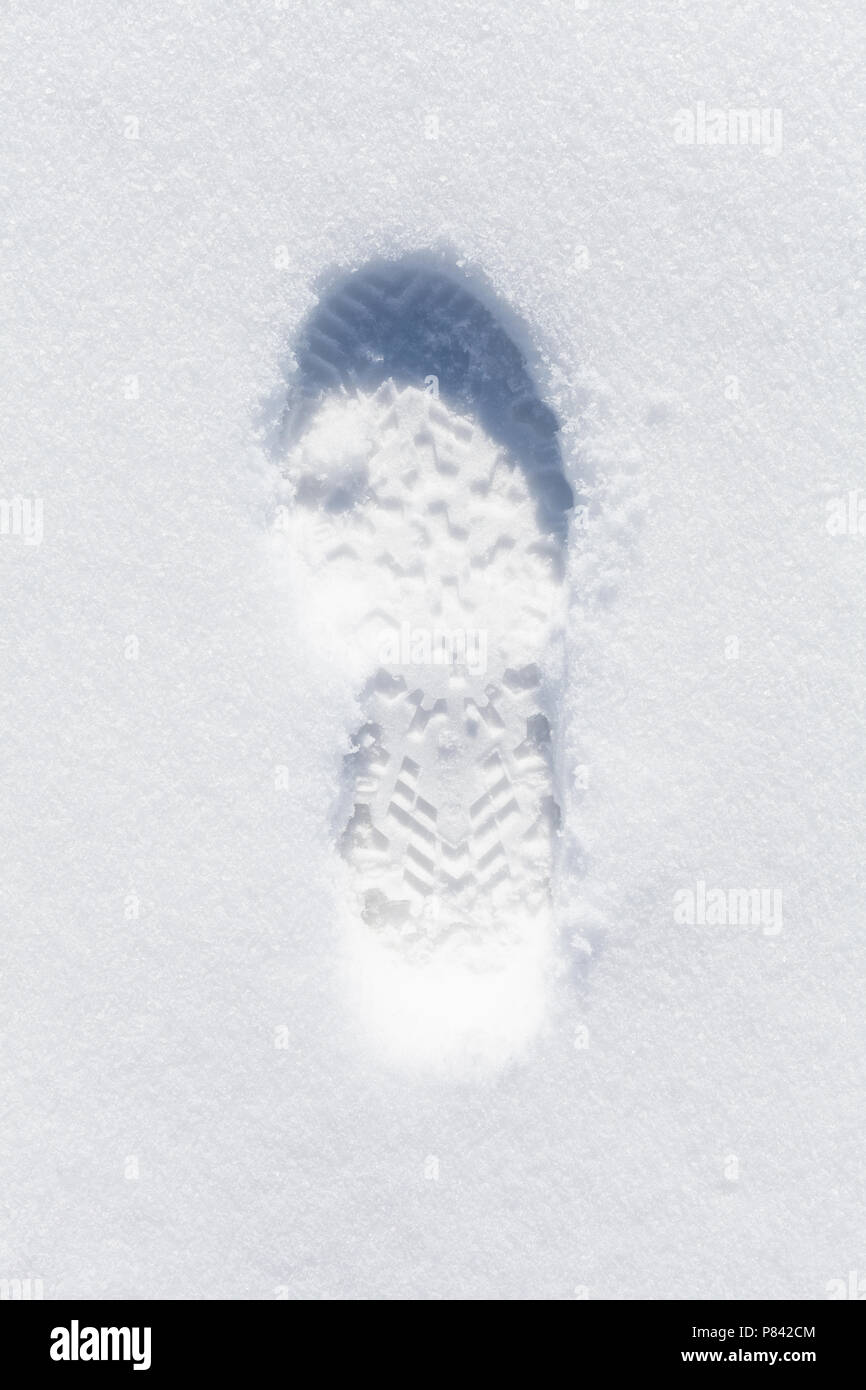 Foot imprint in fresh white snow, top view Stock Photo - Alamy