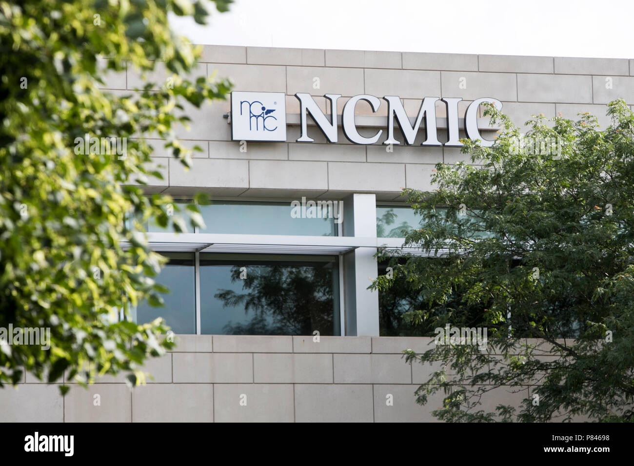 A logo sign outside of the headquarters of the NCMIC Group, Inc., in ...