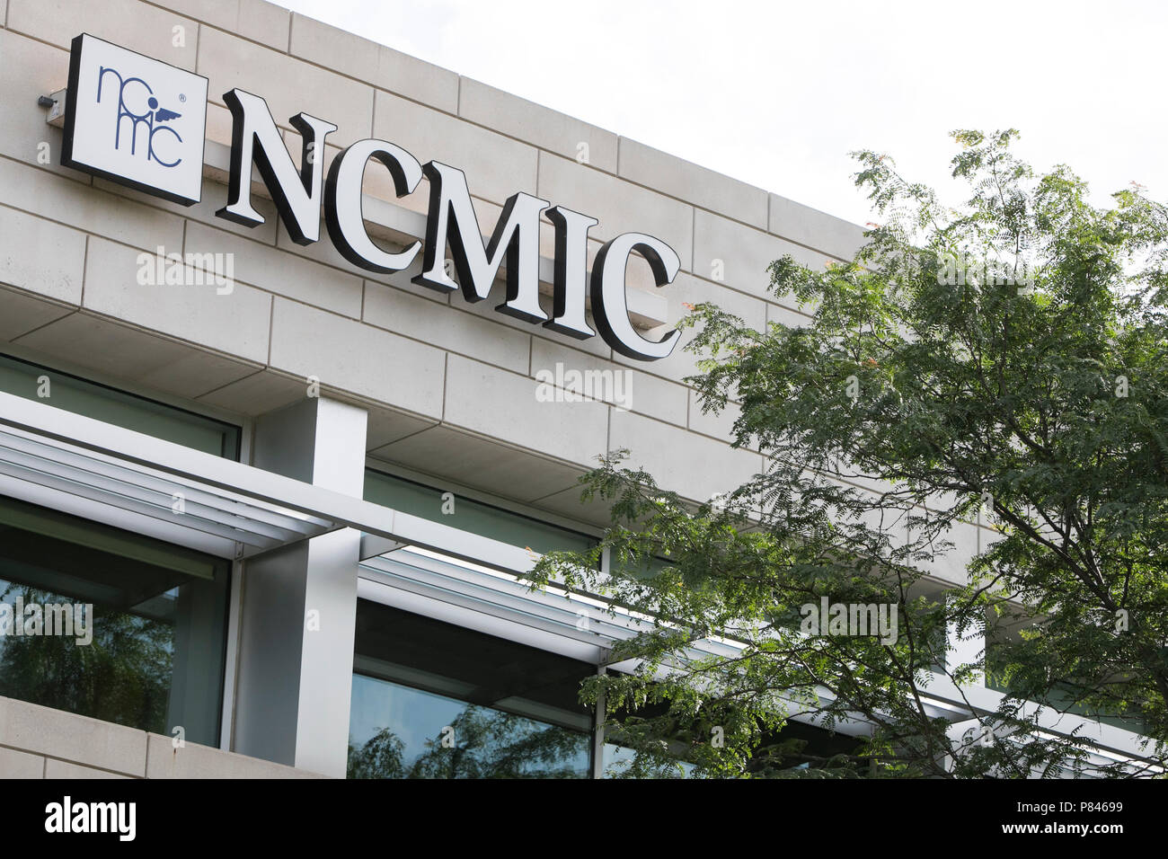 A logo sign outside of the headquarters of the NCMIC Group, Inc., in ...