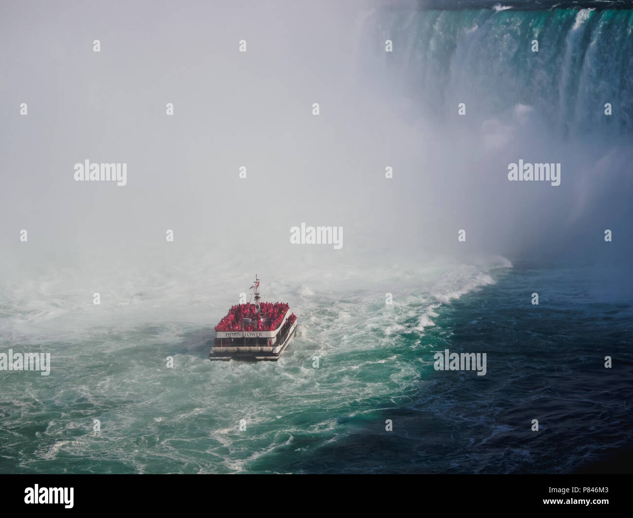 Hornblower full of tourists in front of Horseshoe Falls, Niagara Falls ...