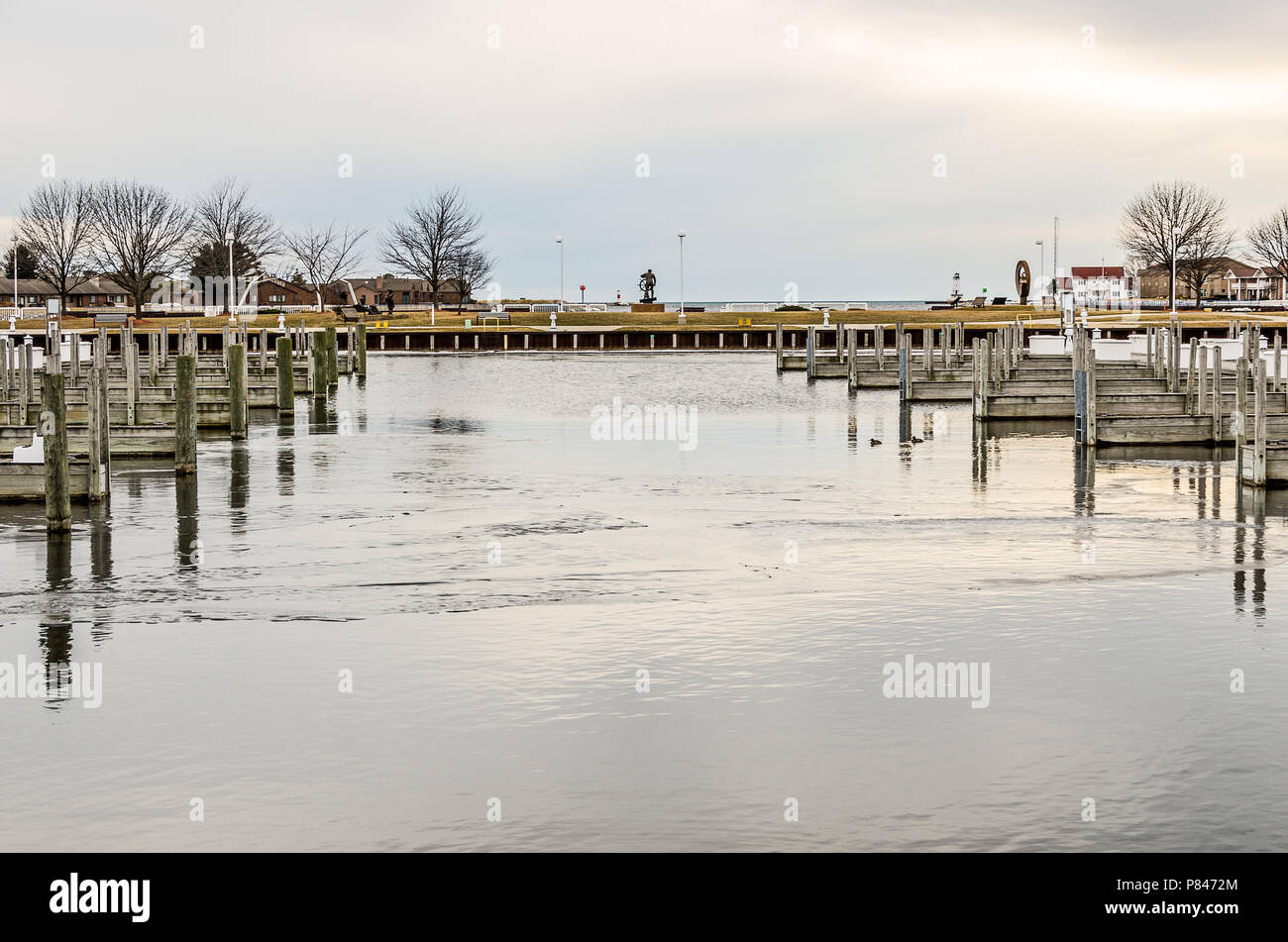Marina with empty docks, a park, a lighthouse, and Lake Michigan Stock ...