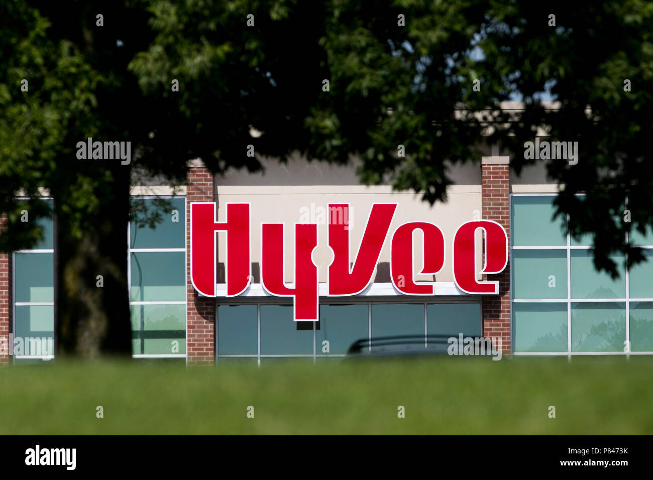 A logo sign outside of a Hy-Vee retail grocery store in West Des Moines ...