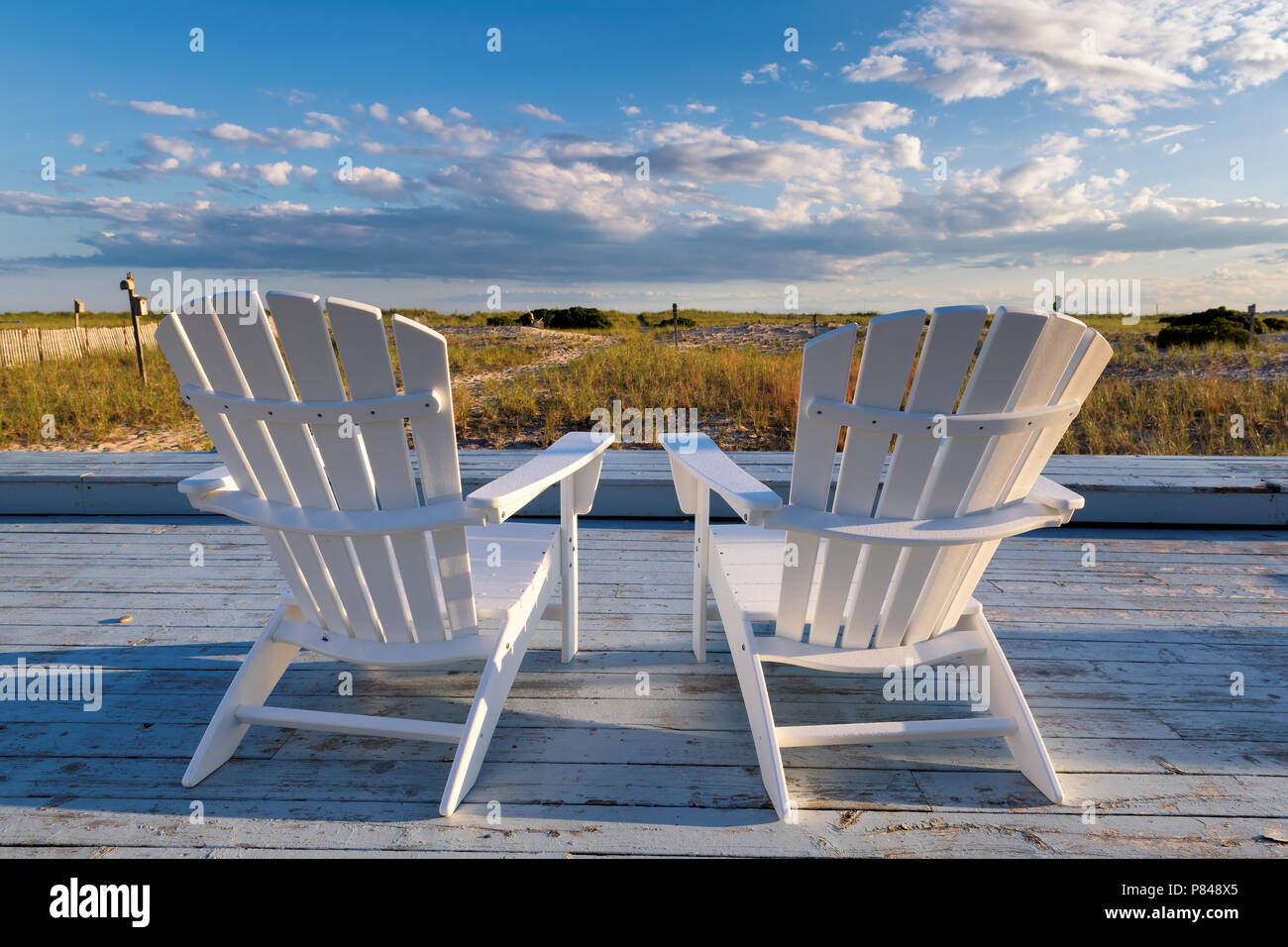 Beach chairs at sunset on vacation beach Stock Photo - Alamy