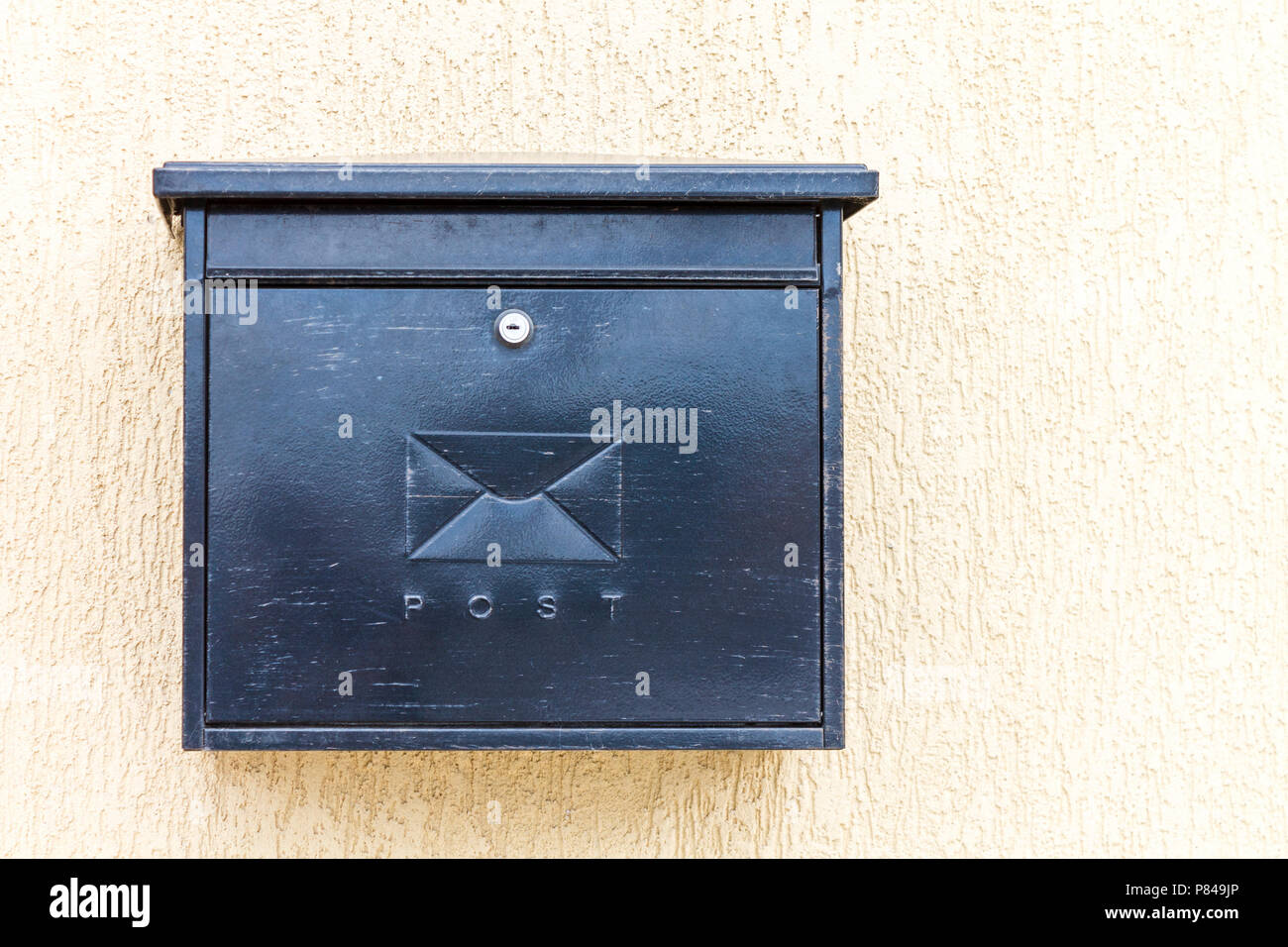 Black metal post box on the wall Stock Photo - Alamy