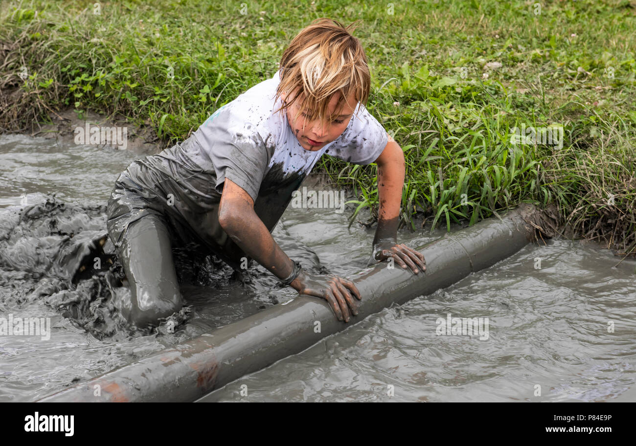 Biddinghuizen, The Netherlands - June 23, 2018: Child during a mudrun ...