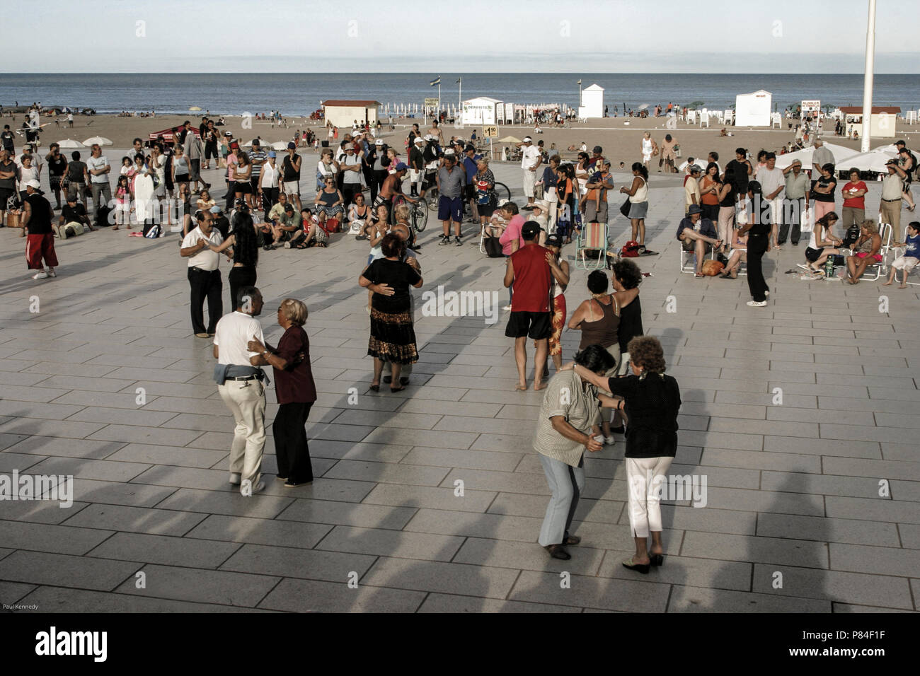 Elderly people dancing outside next to beach in Mar Del Plata ...