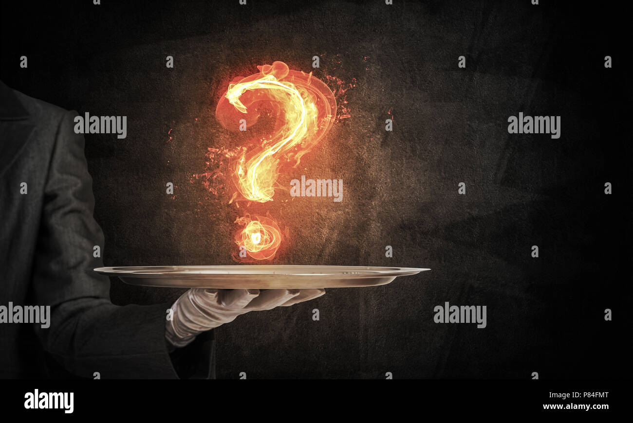 Hand of waitress presenting flaming question mark Stock Photo - Alamy