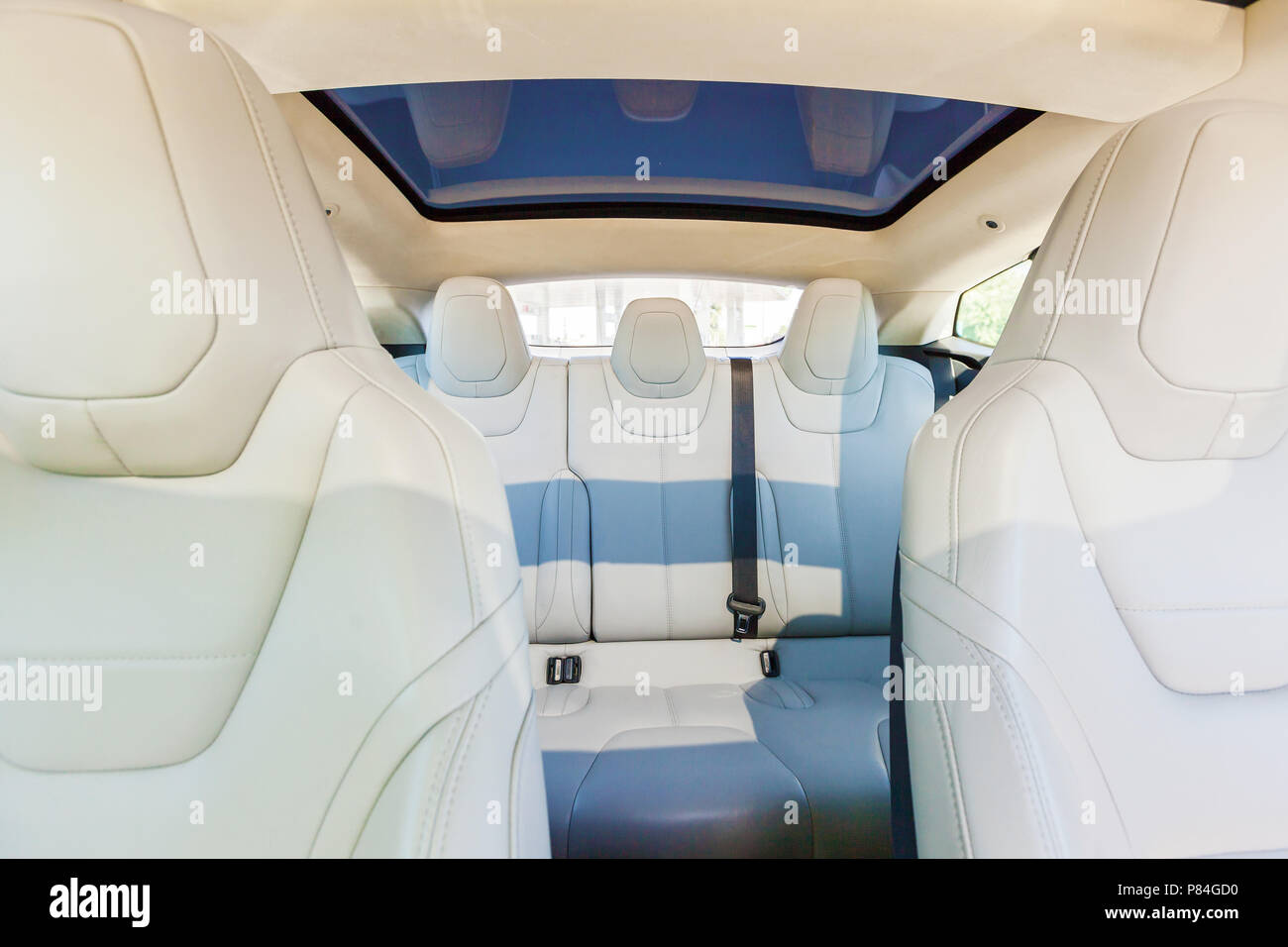 Back passenger seats in modern luxury car, frontal view, white leather ...