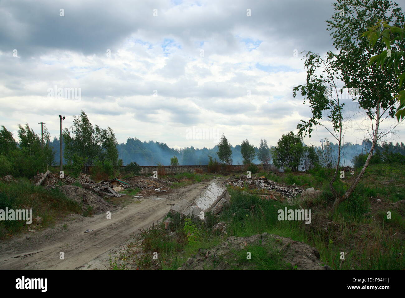 Smoke on the construction dump near the forest Stock Photo - Alamy