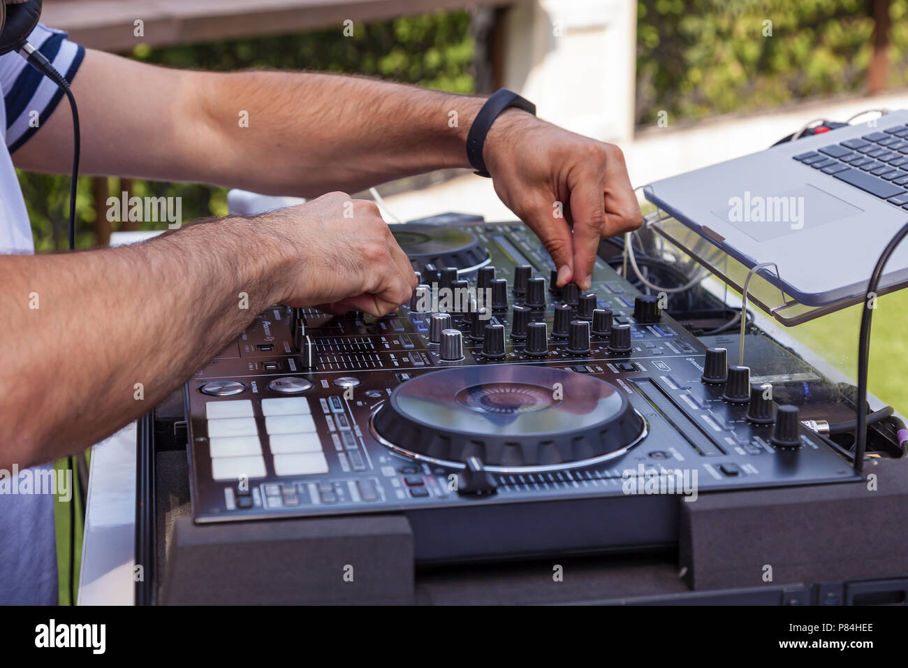 DJ hands on equipment. DJ turntable console mixer controlling with two ...