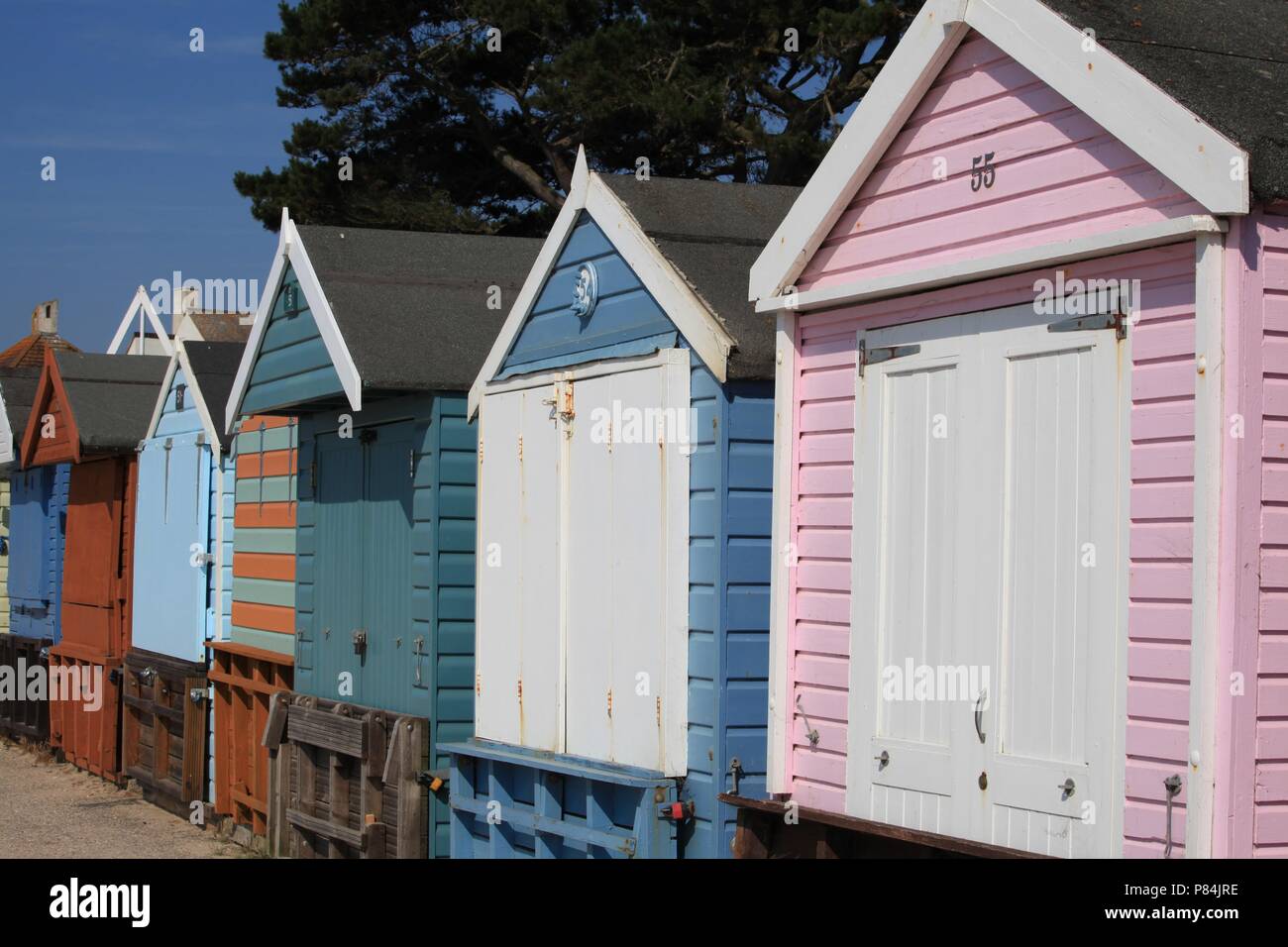Gaily coloured beach huts hi-res stock photography and images - Alamy