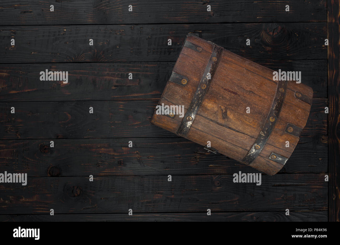 Old closed chest close up on dark wooden table with copy space, top ...