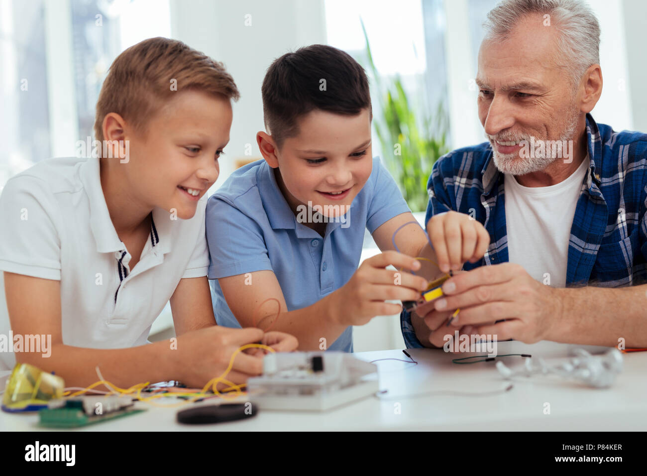 Nice positive boys enjoying engineering Stock Photo - Alamy