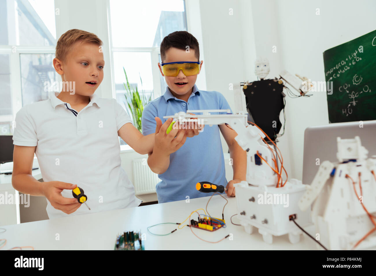 Smart young boys standing in the classroom Stock Photo - Alamy