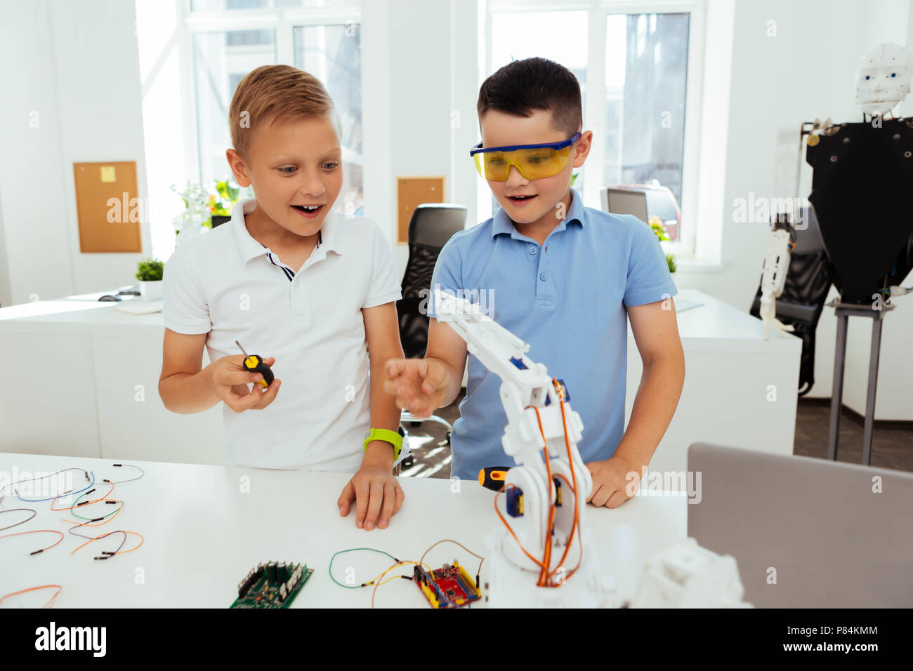 Joyful happy boys working on their science project Stock Photo - Alamy