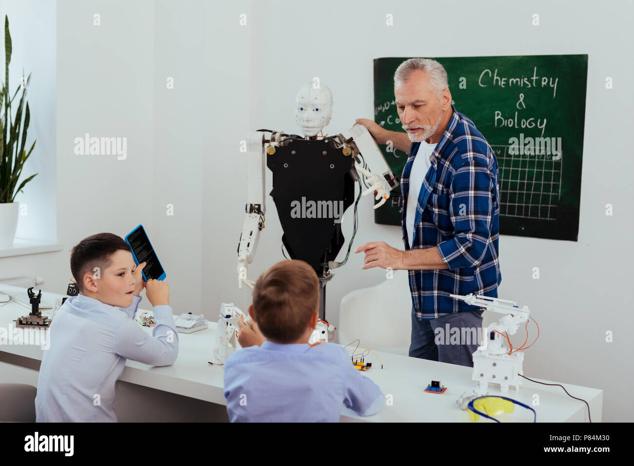 Nice smart man giving a lesson Stock Photo - Alamy