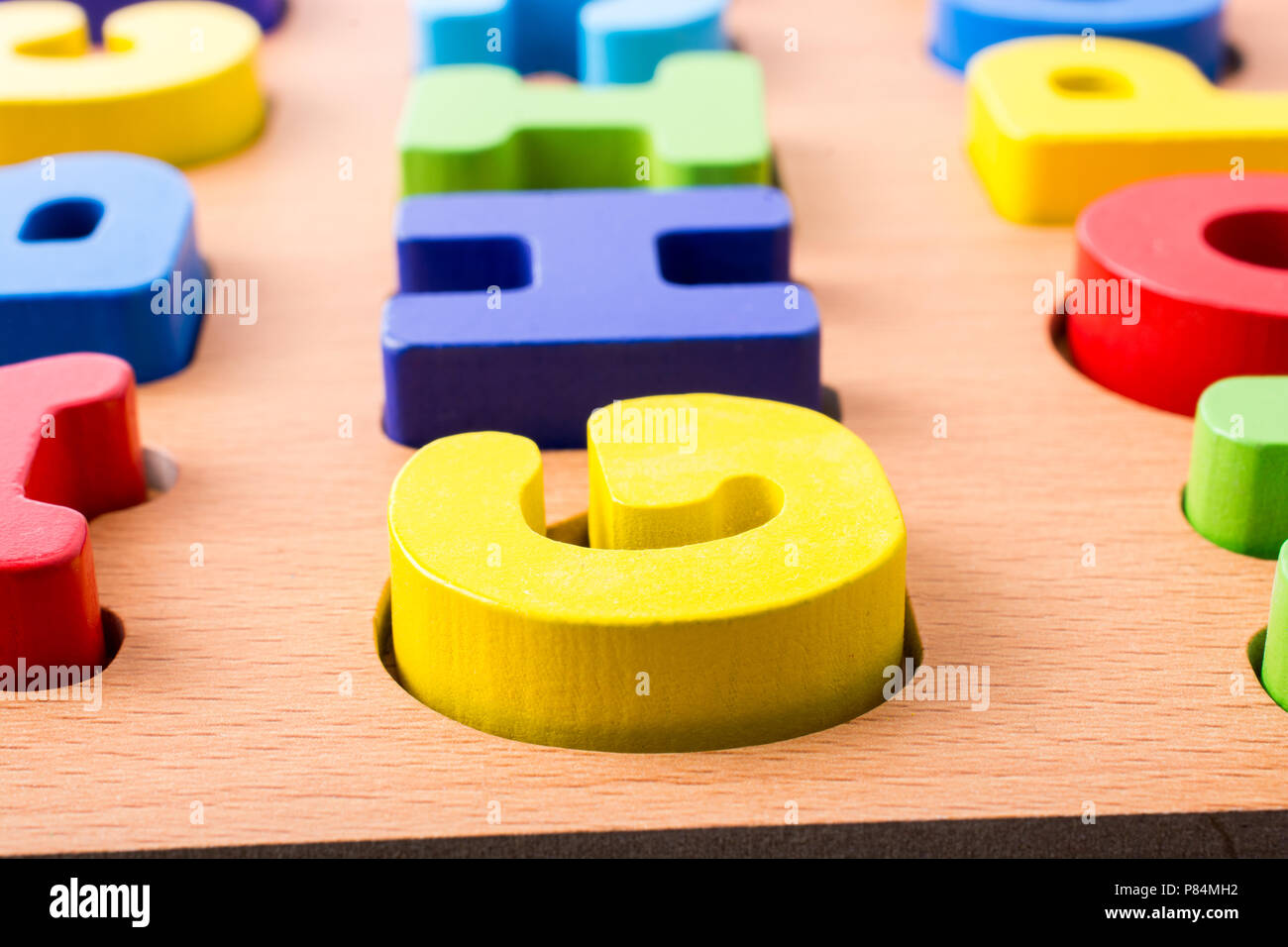 Colorful letter blocks on board on white background Stock Photo - Alamy