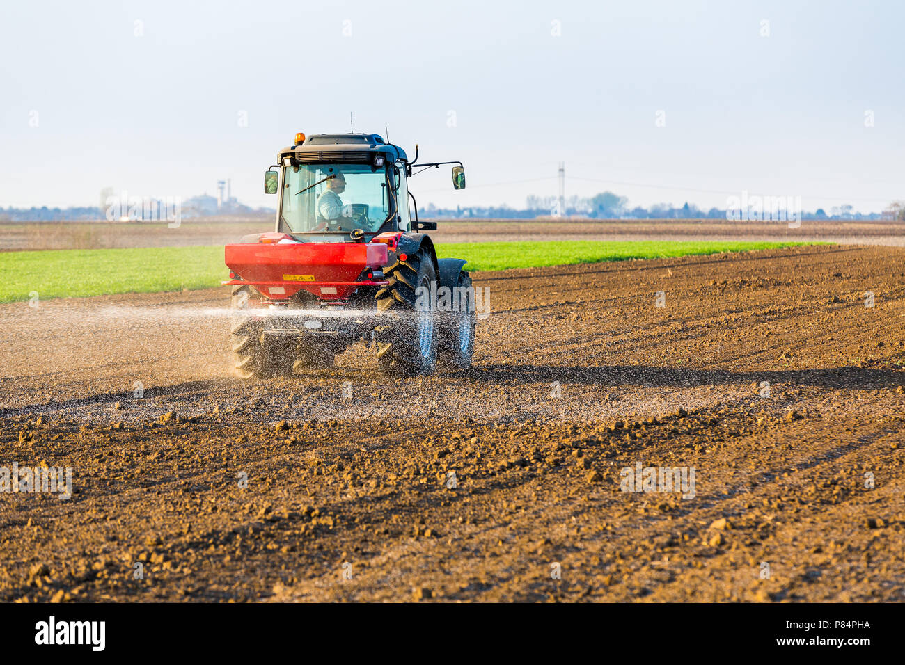 Farmer fertilizing arable land with nitrogen, phosphorus, potassium ...