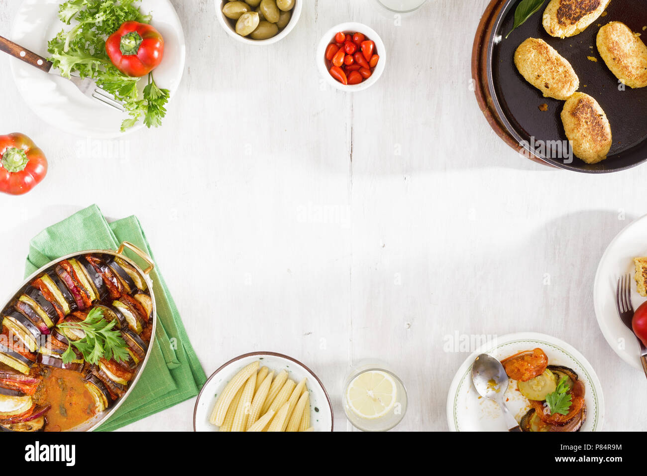 Frame of Different vegetarian food on white wooden table. Vegetarian ...
