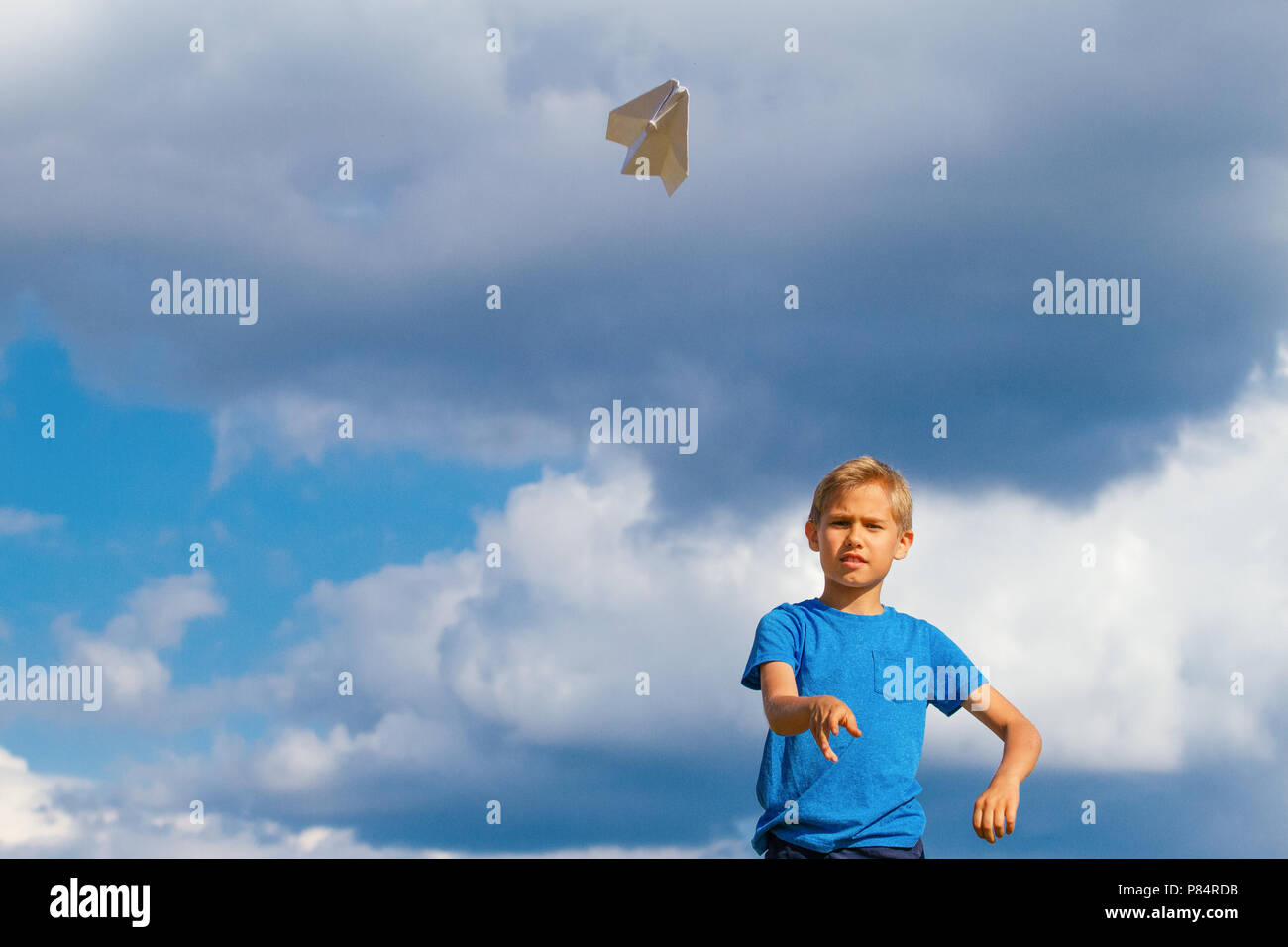 Child throwing paper plane hi-res stock photography and images - Alamy