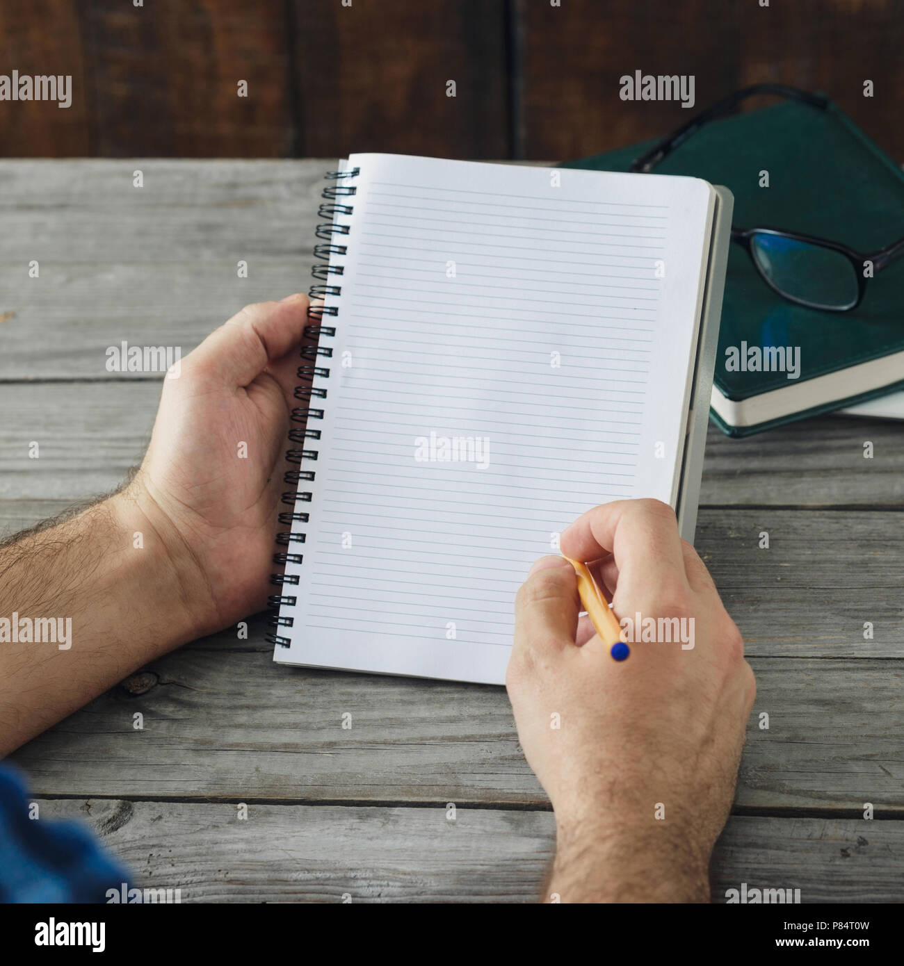 Man writes in a notebook hi-res stock photography and images - Alamy
