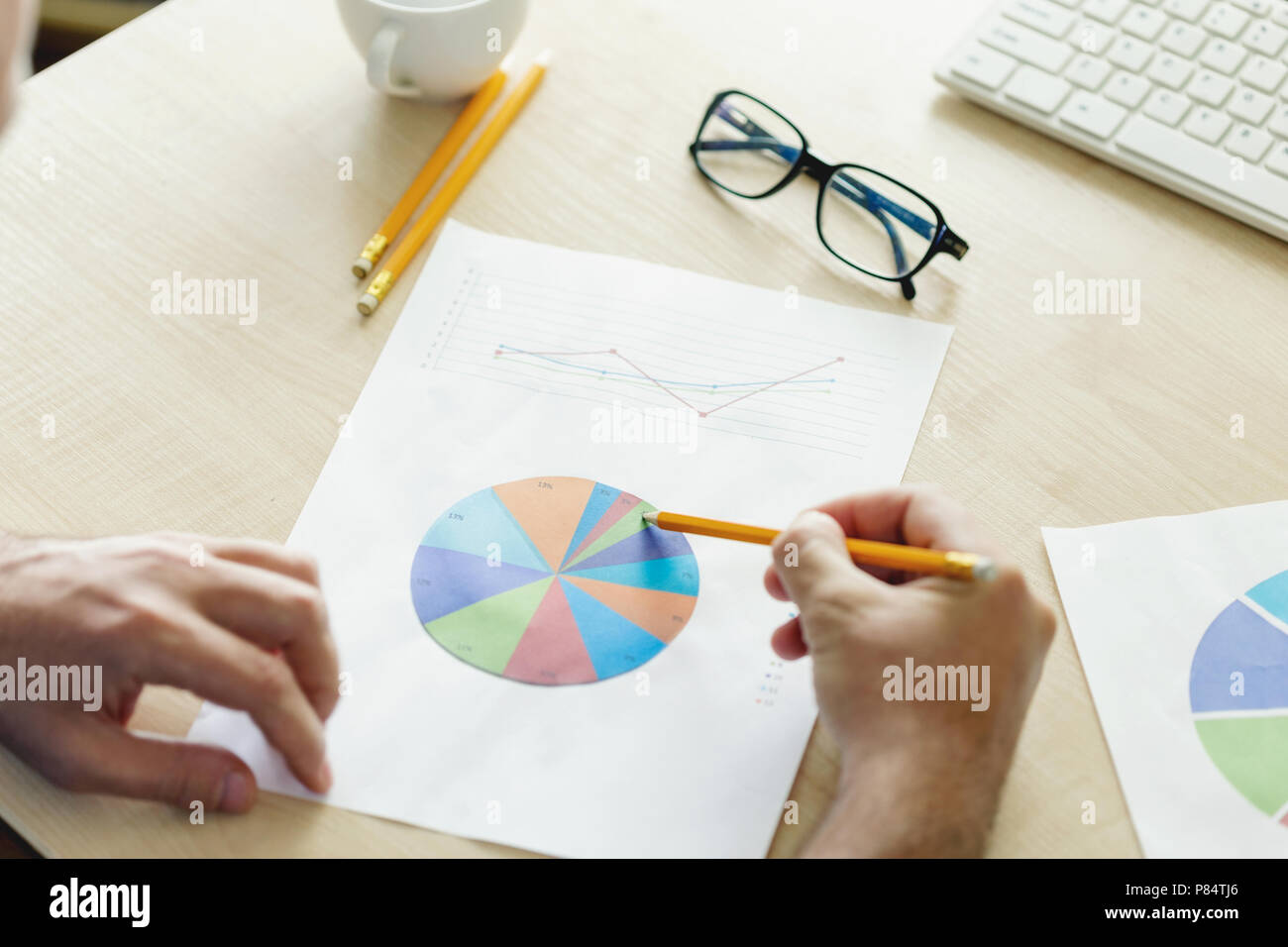 Man analyzes the data and graphs close up. Business Analysis and ...