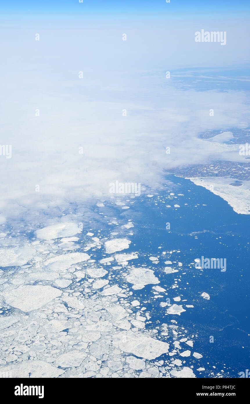 Aerial view of various size sea ice expanses floating near the coast ...