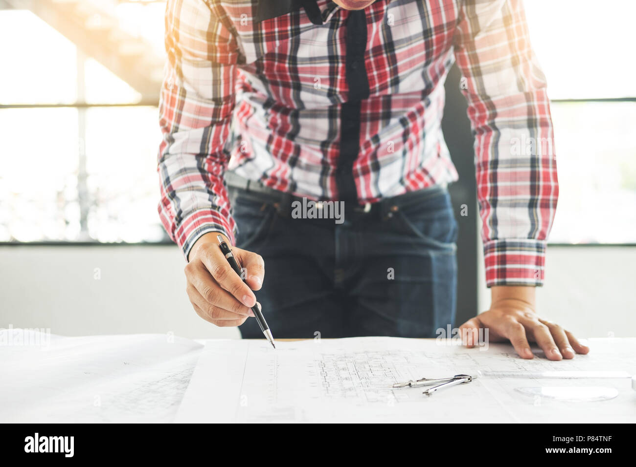 Person's engineer Hand Drawing Plan On Blue Print with architect ...
