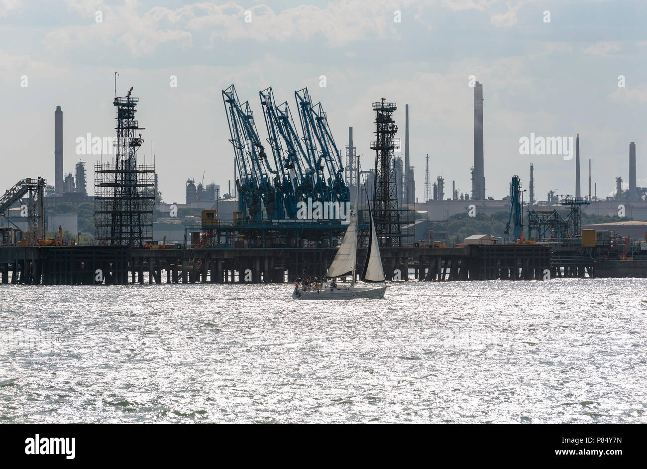 A yacht under sail passing the landscape of the Fawley Refinery on ...
