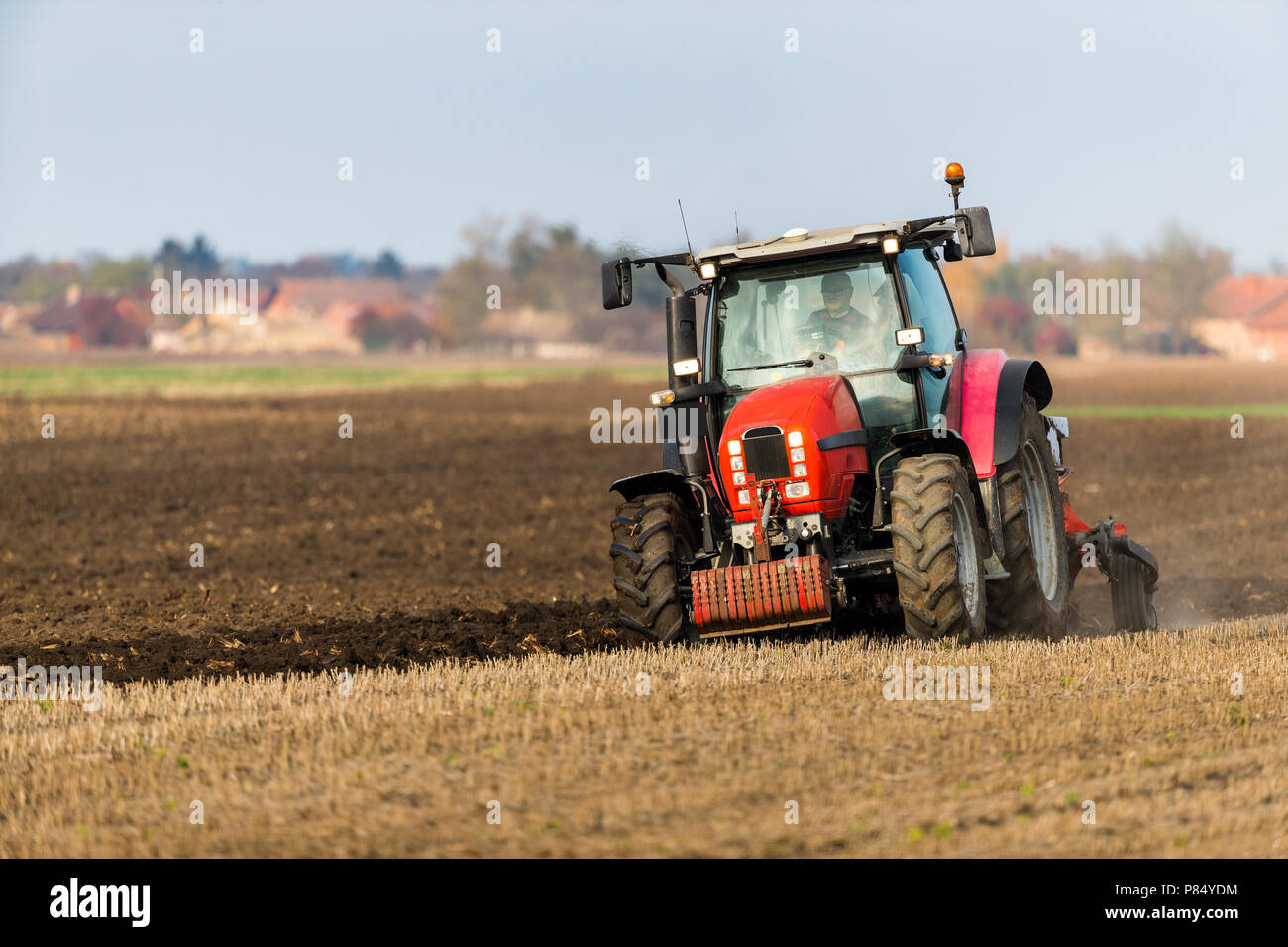 Farmer plowing stubble field Stock Photo - Alamy
