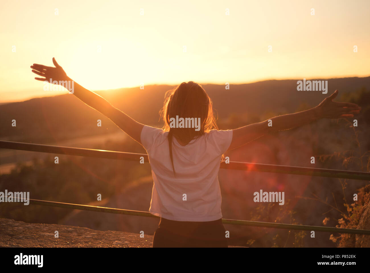 Woman open arms under the sunset. Concept of healthy life Stock Photo ...