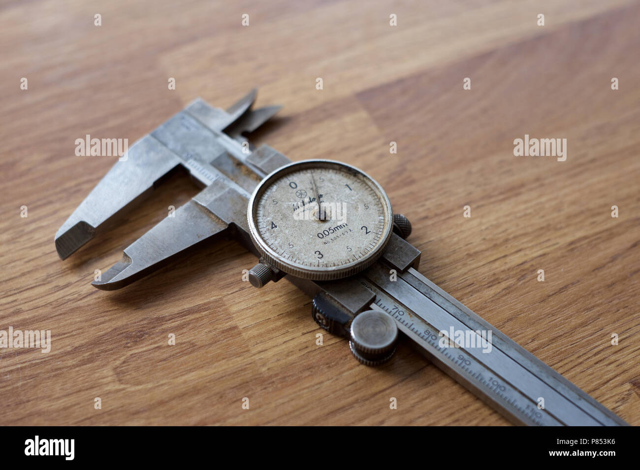 Metric analogue vernier gauge on the work bench Stock Photo - Alamy
