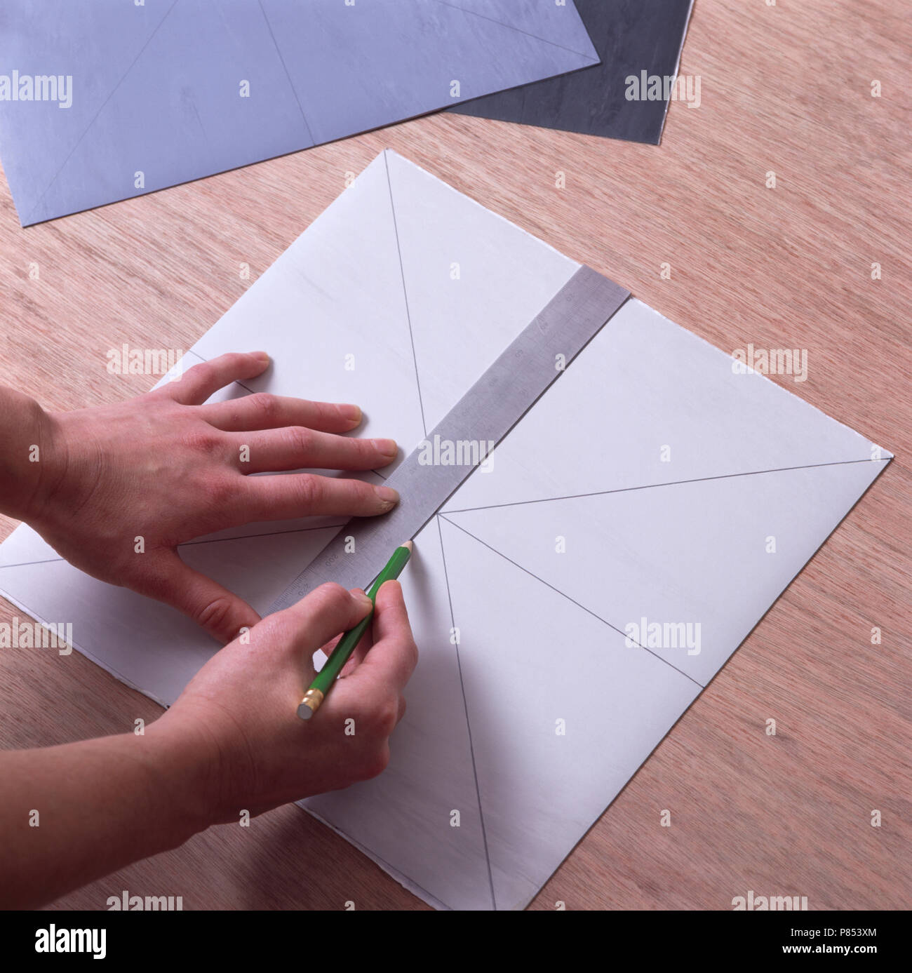 Close-up of hands marking out pattern for a painted floor mat Stock ...
