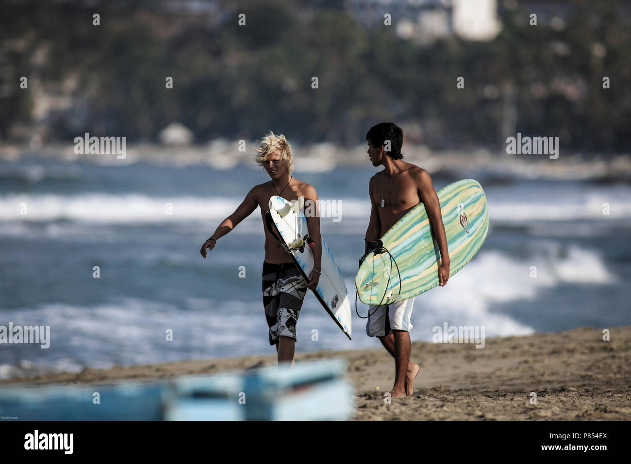 Surfers walking along Zicatela beach after surf, Puerto Escondido ...