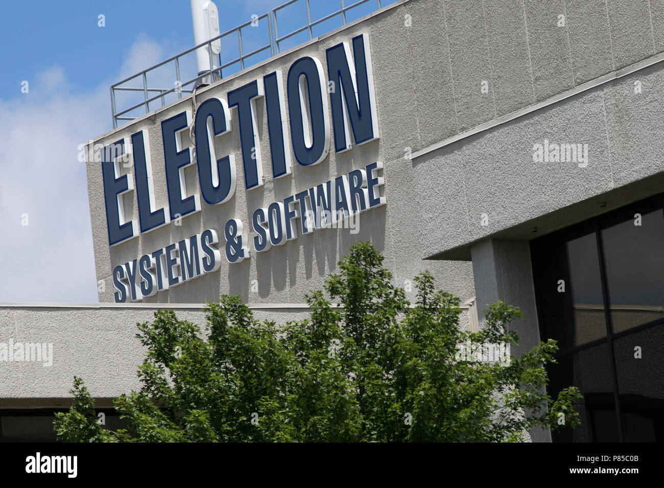 A logo sign outside of the headquarters of Election Systems & Software ...