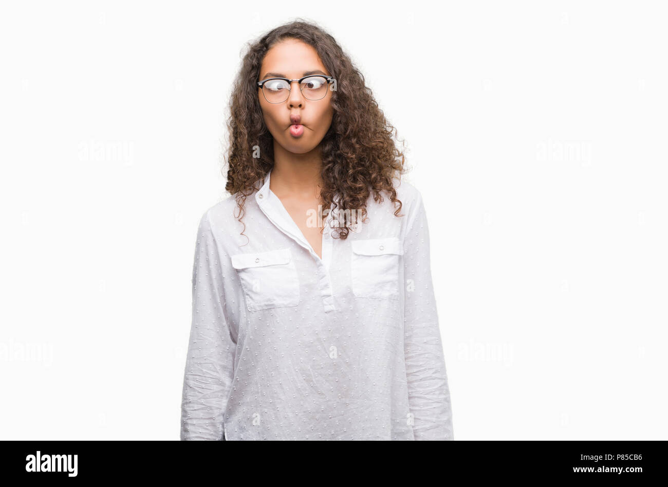 Beautiful young hispanic woman making fish face with lips, crazy and ...