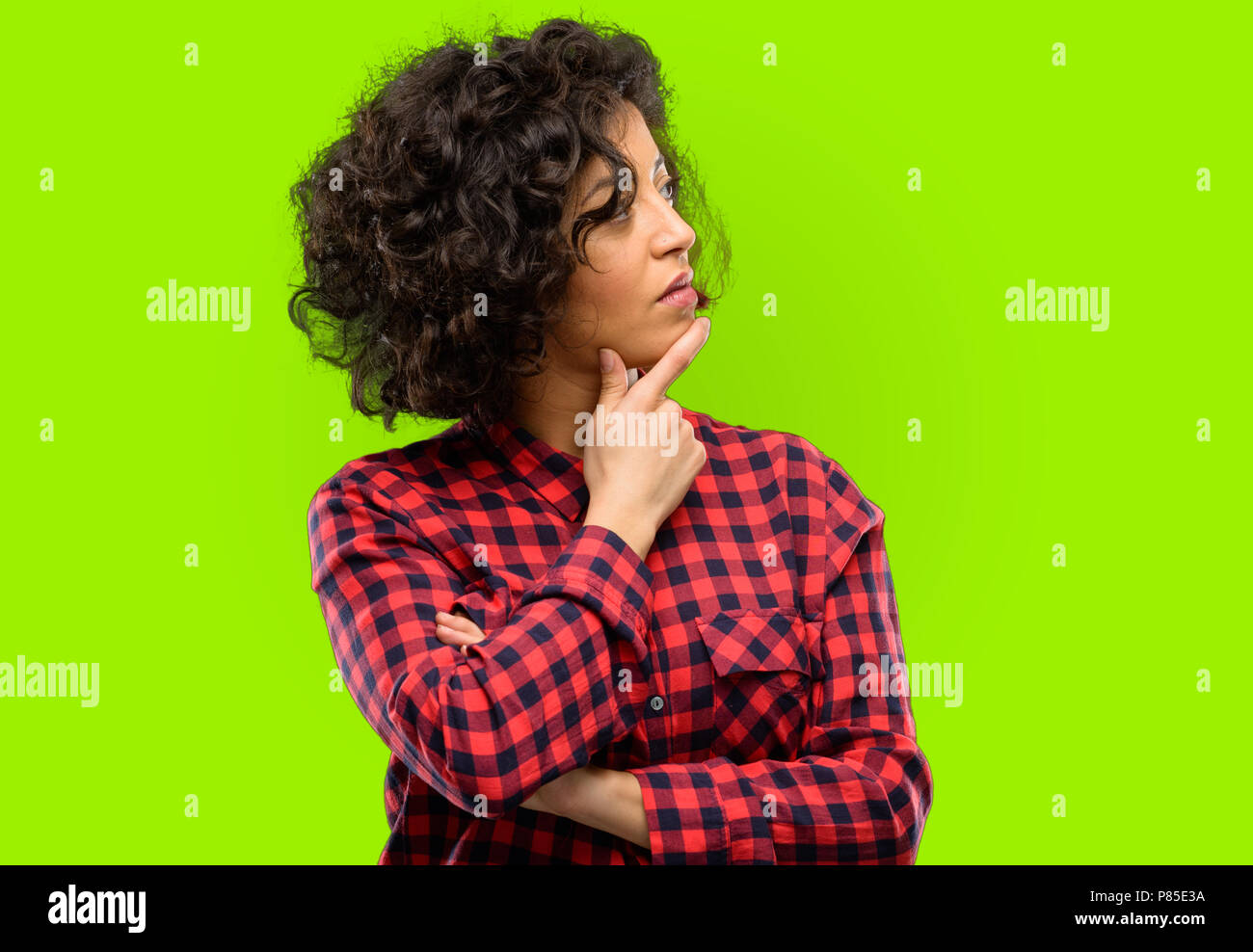 Beautiful arab woman thinking and looking up expressing doubt and ...
